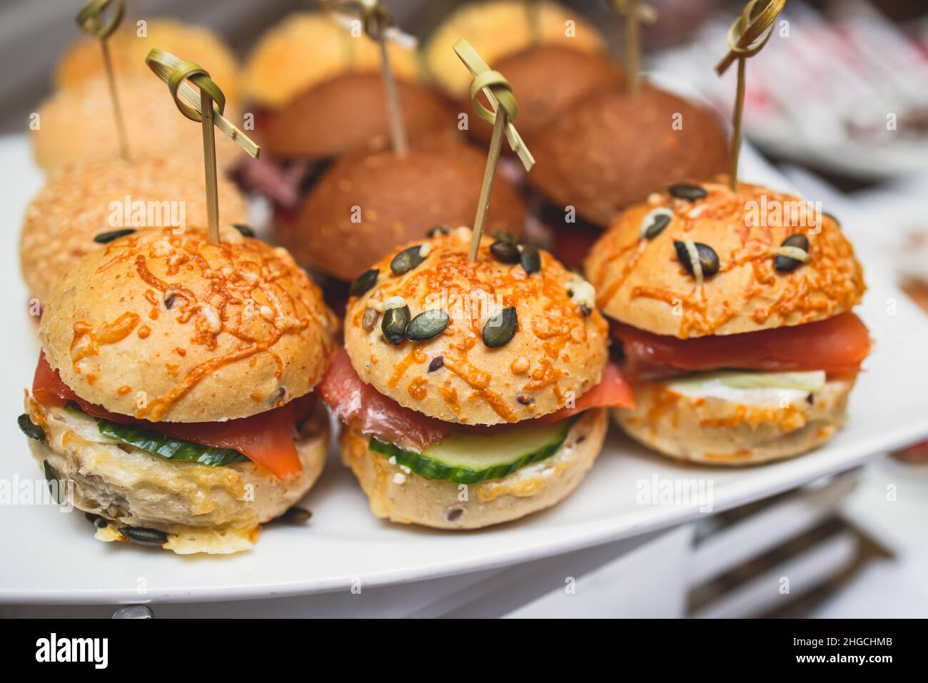 Burger mini burgers snacks on a wooden table with craft paper ...