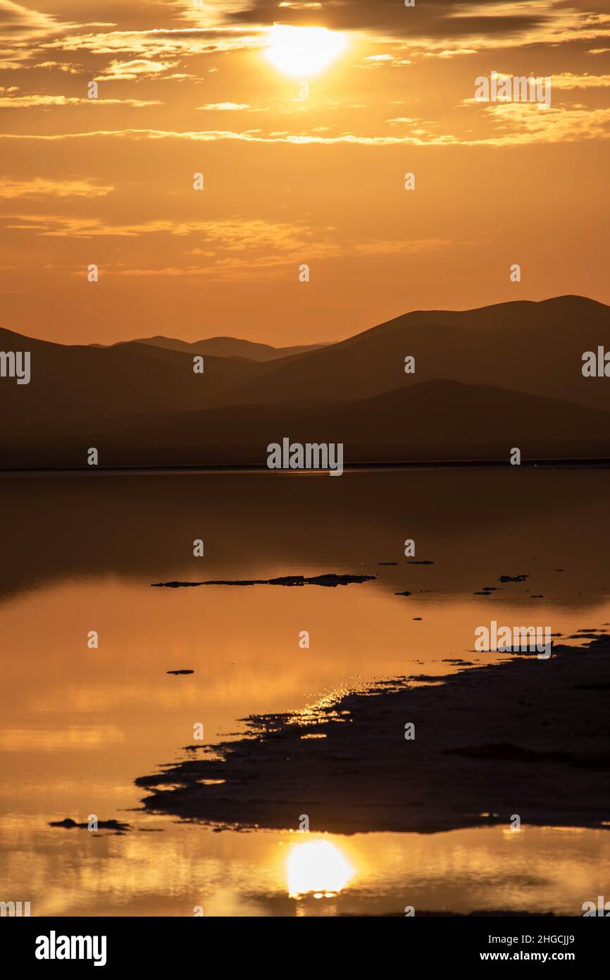 Sunset and full reflection of the sun in the lake Stock Photo - Alamy