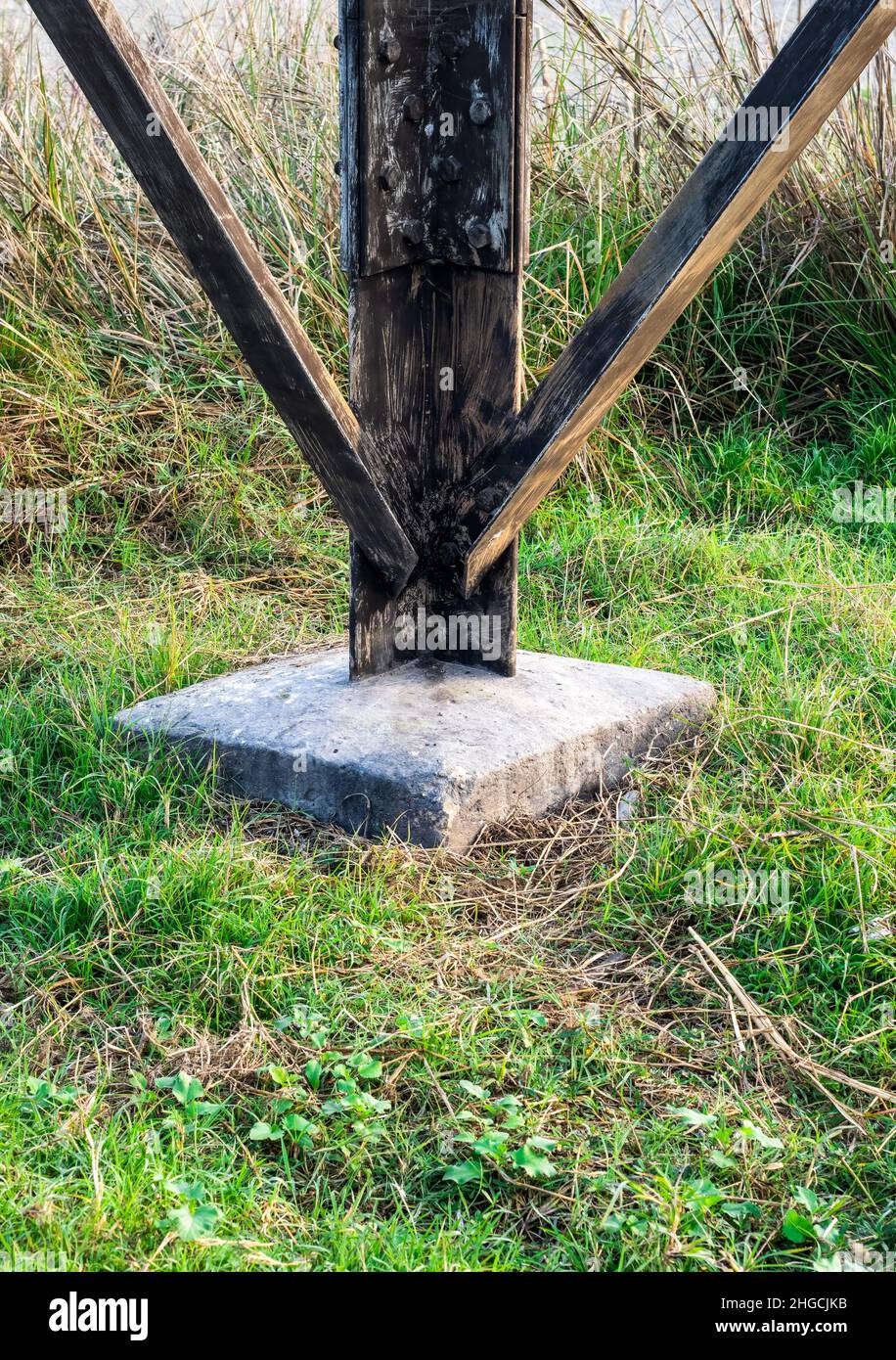 A ground pillar of high voltage electricity transmission tower close up ...