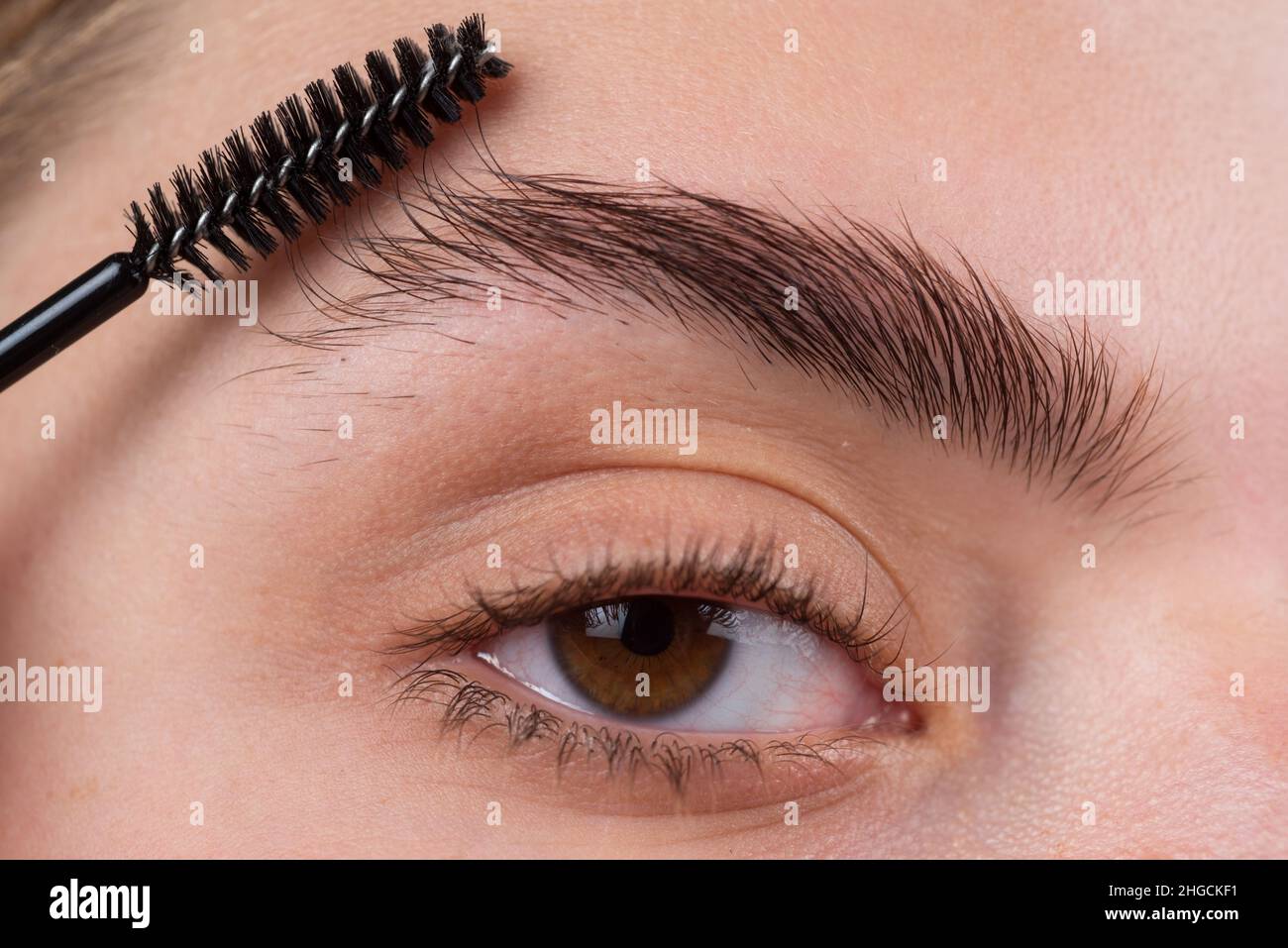 Eyebrow makeup. Beauty model shaping brows with brow pencil closeup ...