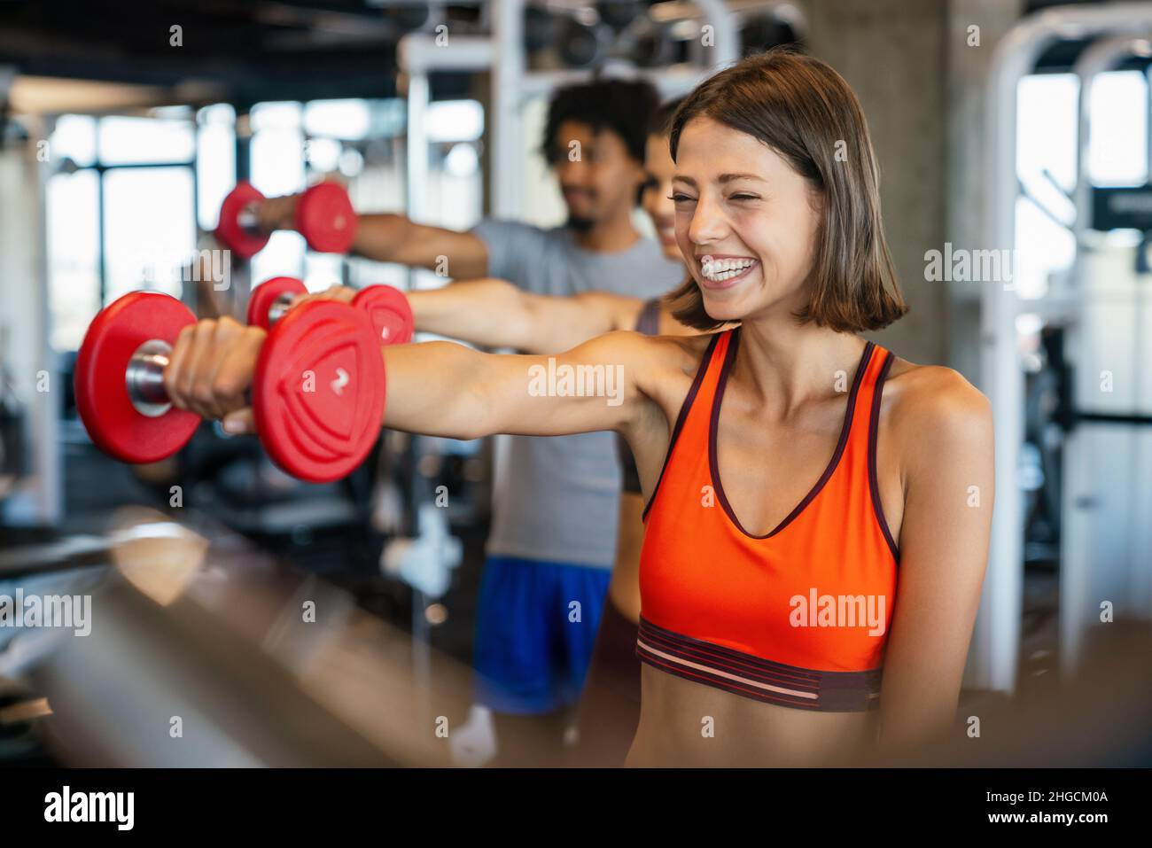 Beautiful fit people working out in gym together Stock Photo - Alamy