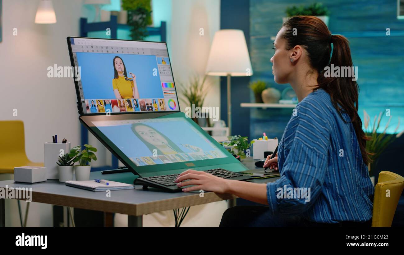 Professional artist editing pictures using retoucher on touch screen ...