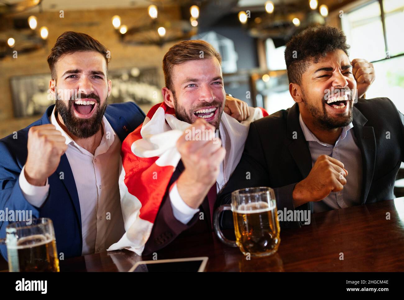 Business men in pub cheering for a sporting event Stock Photo - Alamy