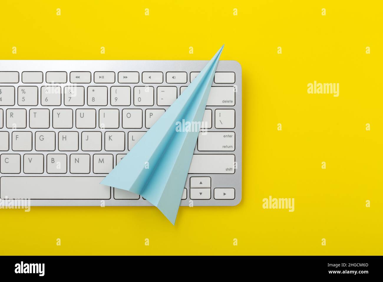 Rocket on computer keyboard on yellow background, online startup ...