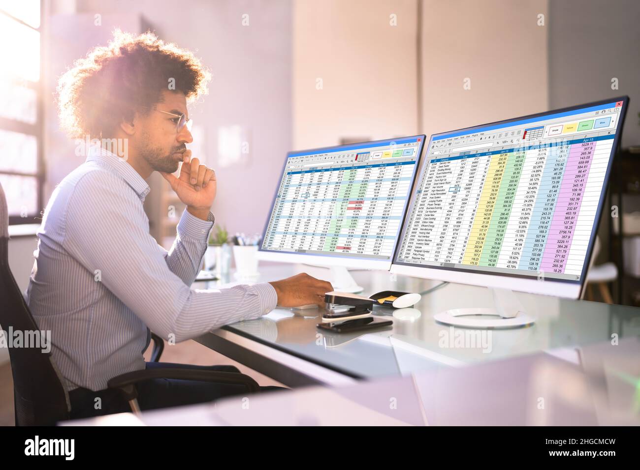 Data Analyst African Man Using Spreadsheet On Computer Stock Photo - Alamy