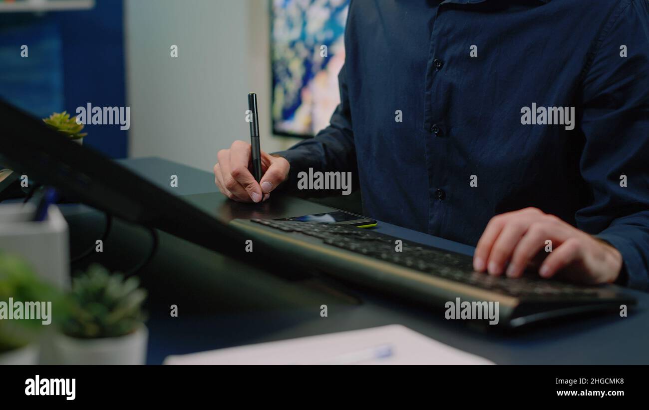 Close up of photographer using graphic tablet and stylus editing ...