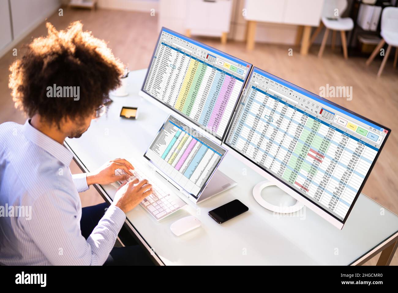 Data Analyst African Man Using Spreadsheet On Computer Stock Photo - Alamy