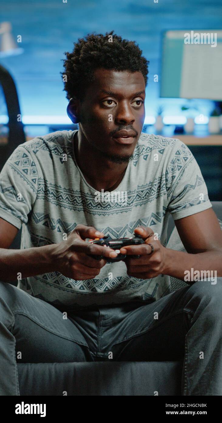 Person playing video games with joystick and TV console at home. Man ...