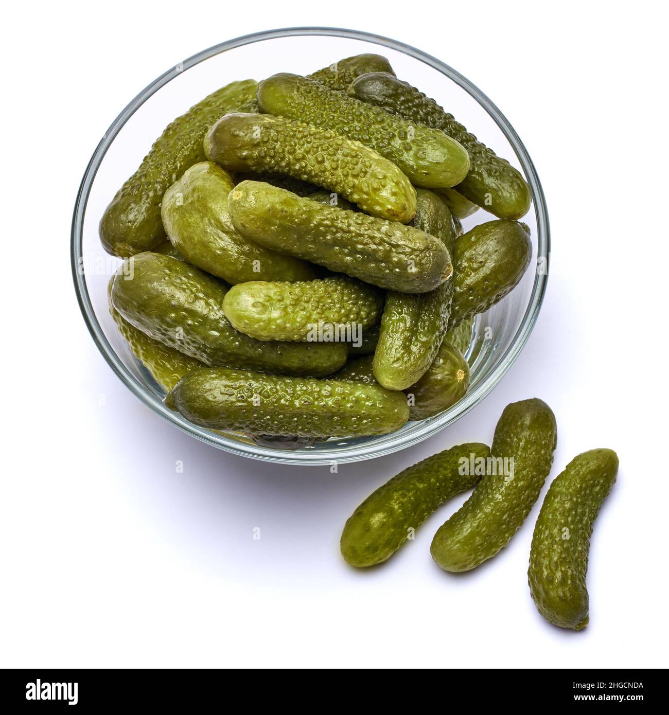 Bowl of Tasty canned Whole green cornichons isolated on a white ...