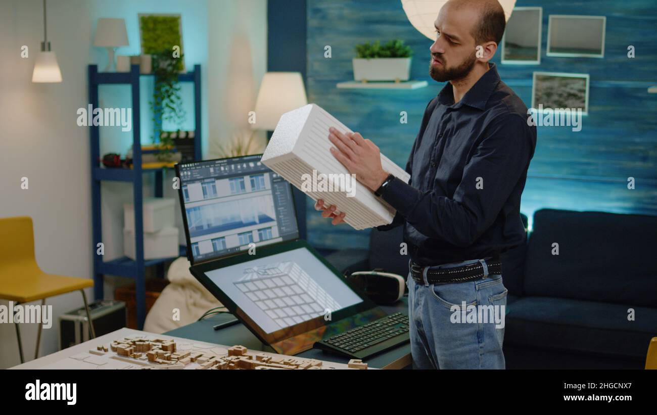 Man Working As Architect Analyzing Maquette In Hand Young Engineer Checking Building Model With