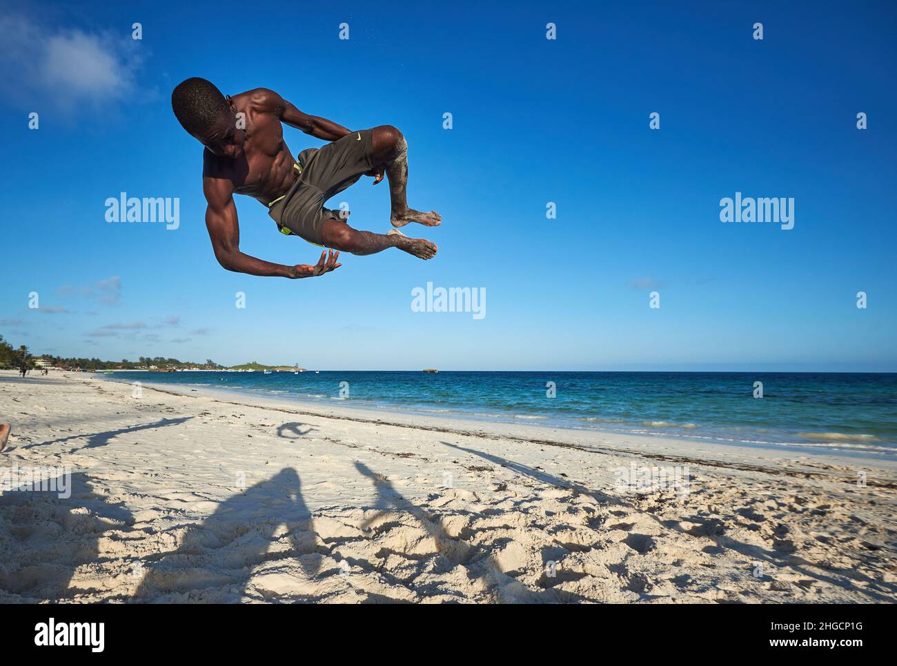 Boy performing action acrobatic jump of African young male Aerial ...