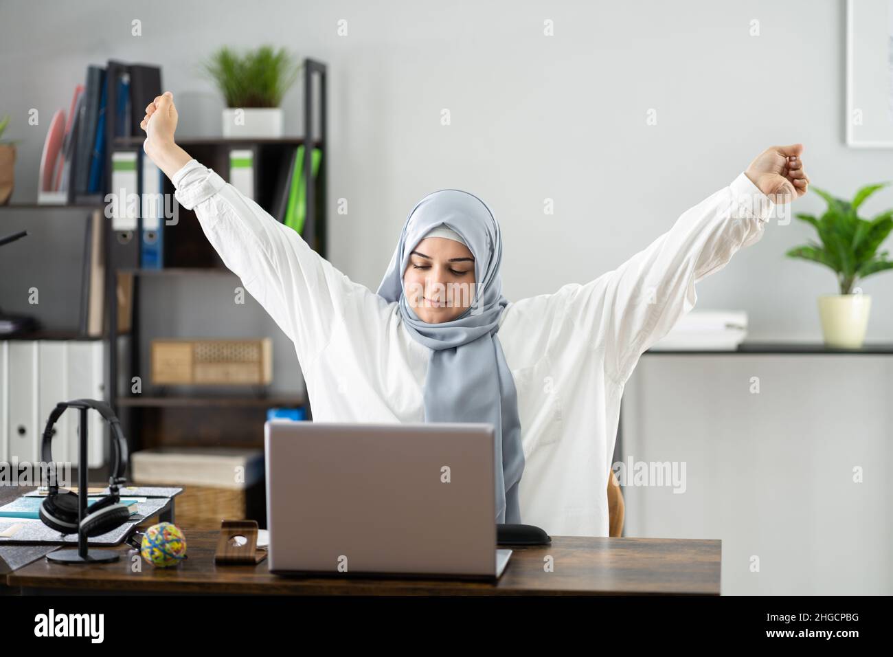 Stretch Exercise At Office Desk Near Computer Stock Photo - Alamy