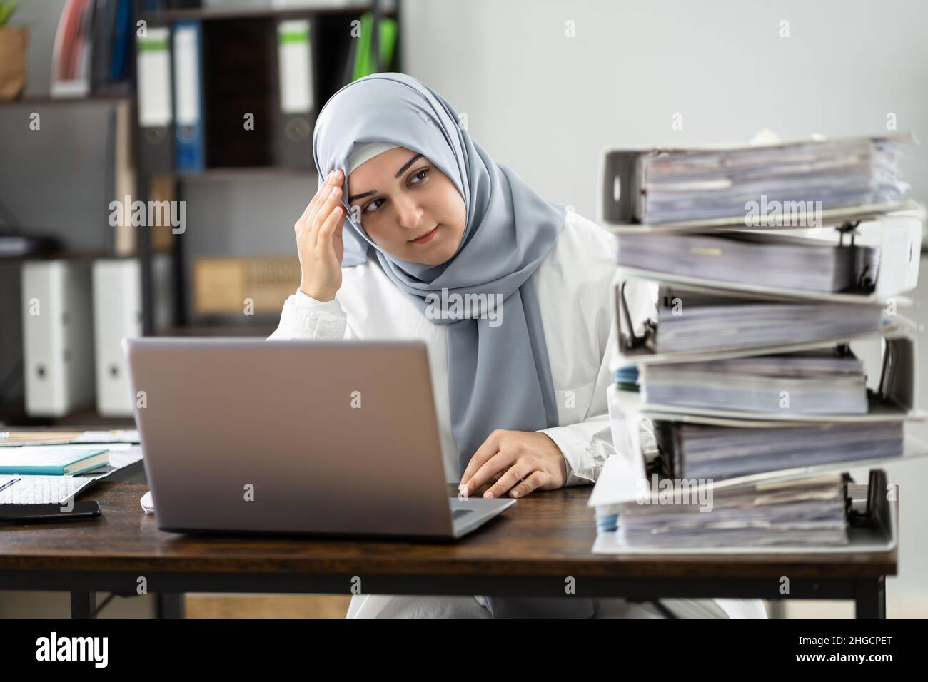 Frustrated Workaholic Woman In Office Filing Tax Stock Photo - Alamy