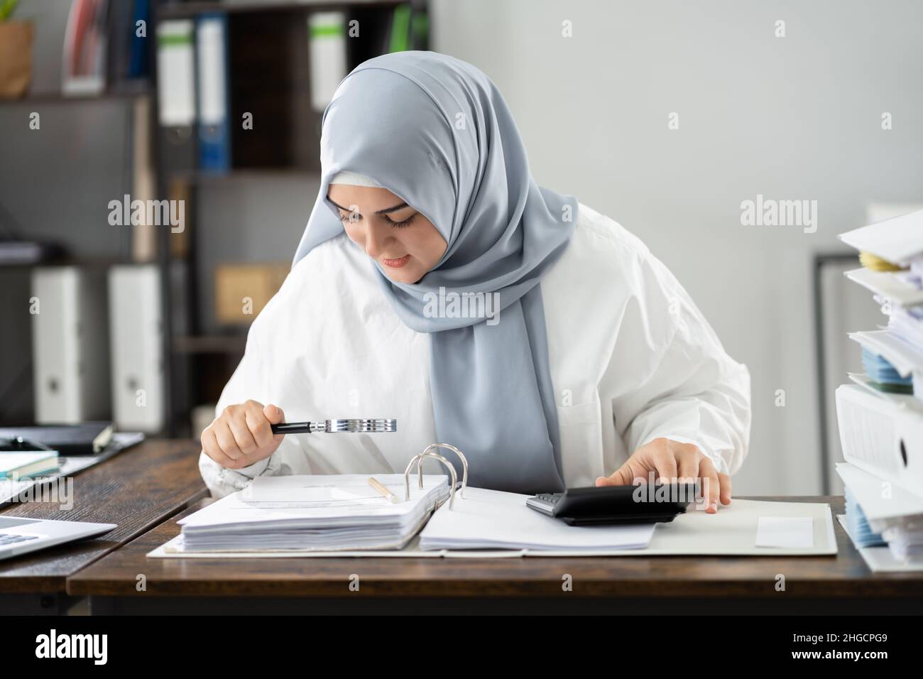 Muslim Auditor Woman Doing Fraud Audit Using Magnifying Glass Stock ...