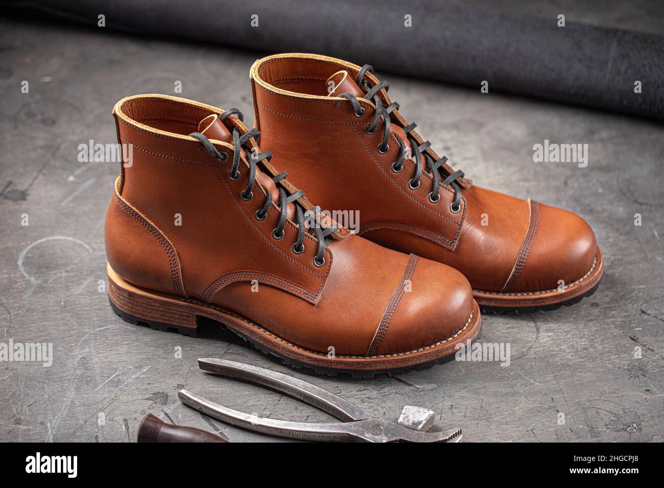 Handcrafted brown leather shoes with cobbler tools Stock Photo - Alamy