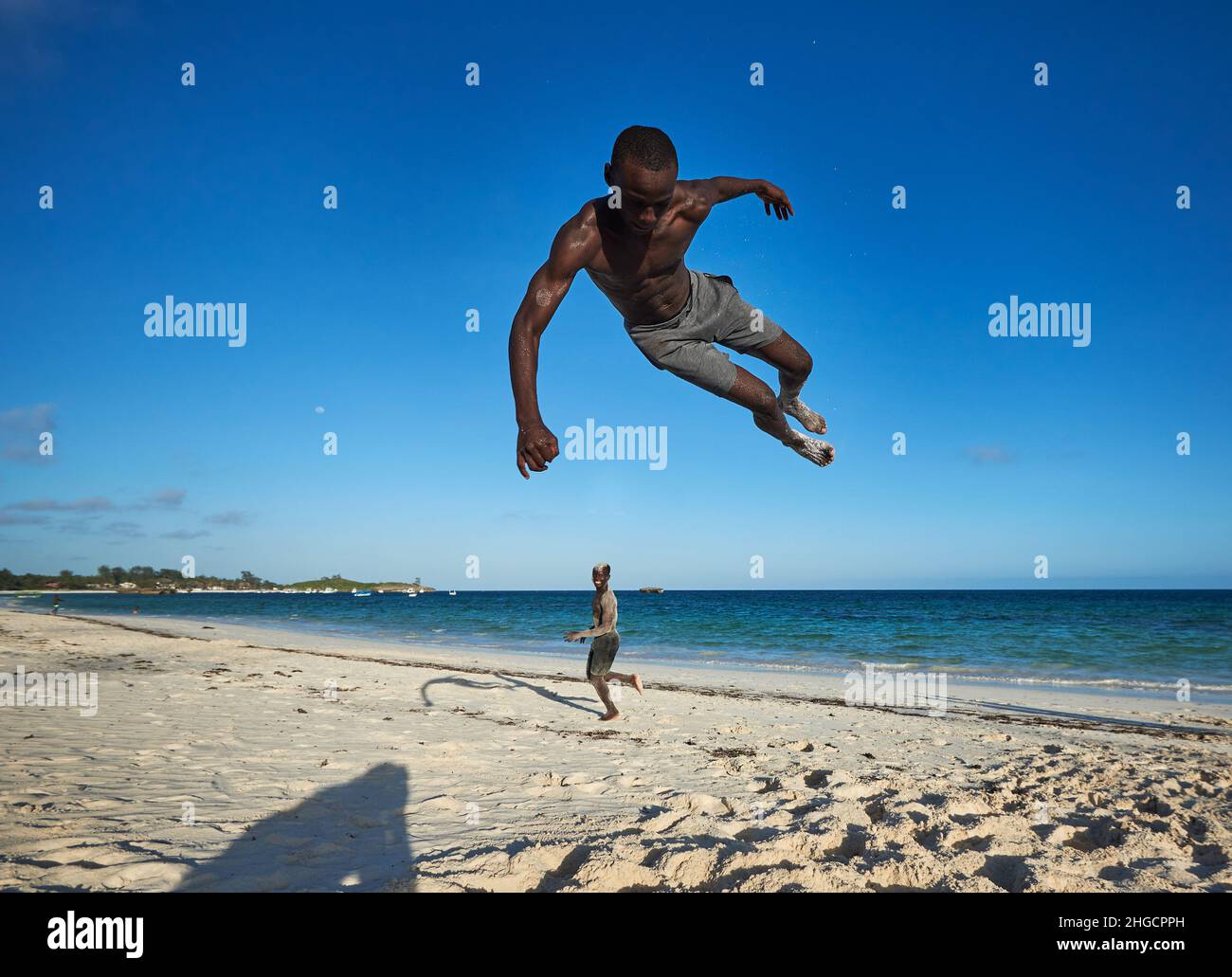 Boy performing action acrobatic jump of African young male Aerial ...