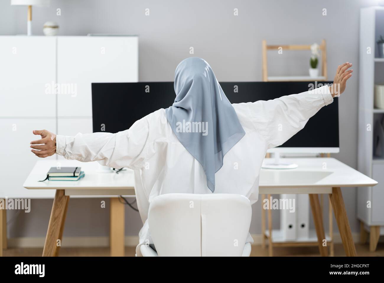 Stretch Exercise At Office Desk Near Computer Stock Photo - Alamy