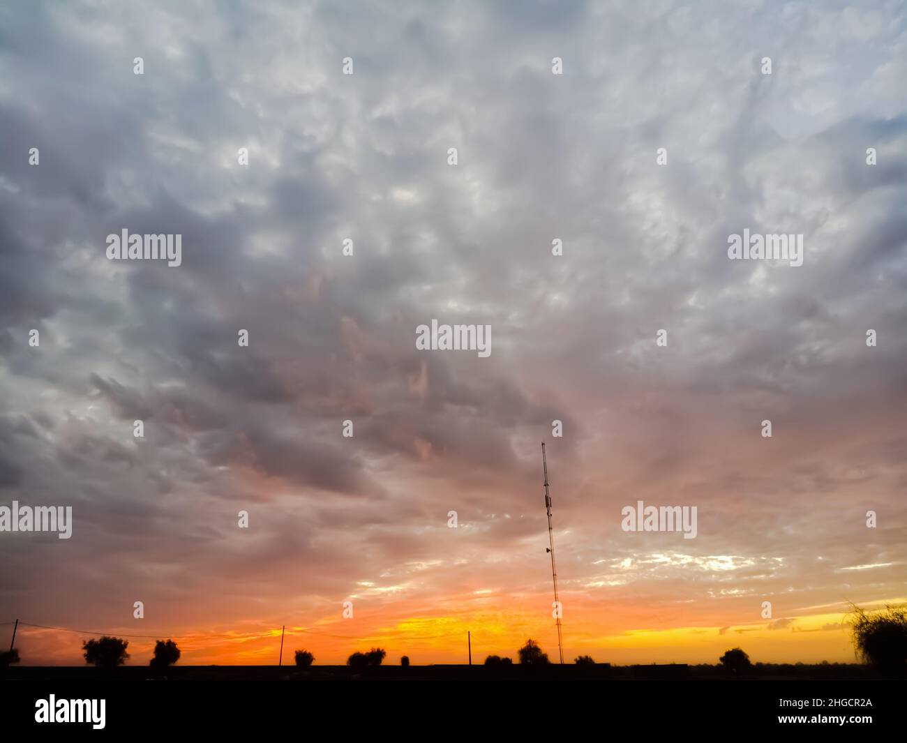 Evening Sunset Landscape With Orange Sky With Clouds Stock Photo - Alamy
