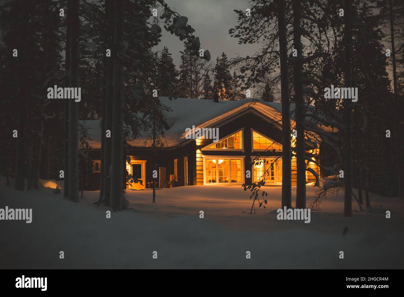 A view of cozy wooden scandinavian cabin cottage chalet house covered ...