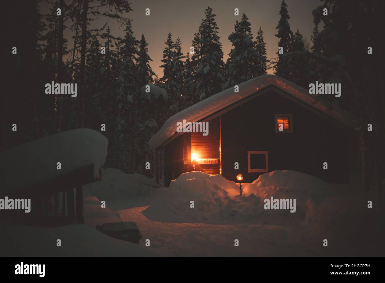 A view of cozy wooden scandinavian cabin cottage chalet house covered ...