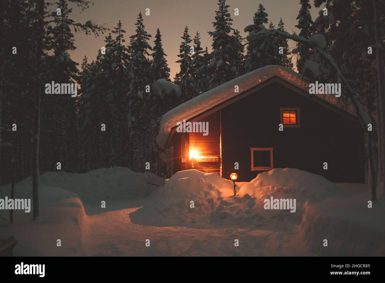 A view of cozy wooden scandinavian cabin cottage chalet house covered ...