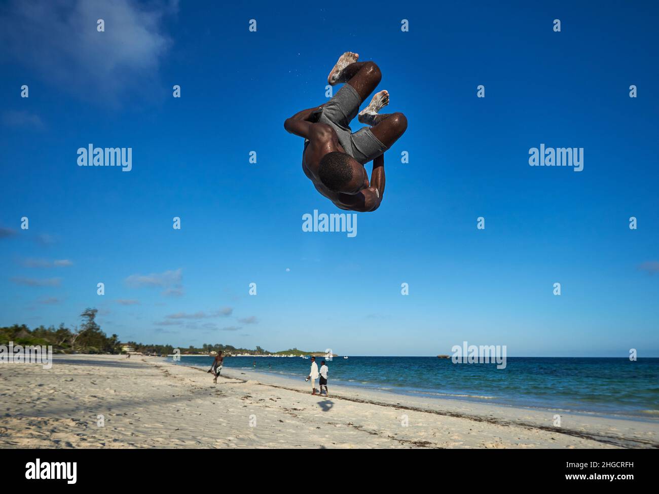Boy performing action acrobatic jump of African young male Aerial ...