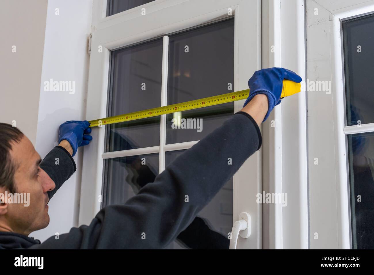 Construction worker installing window in house Stock Photo - Alamy