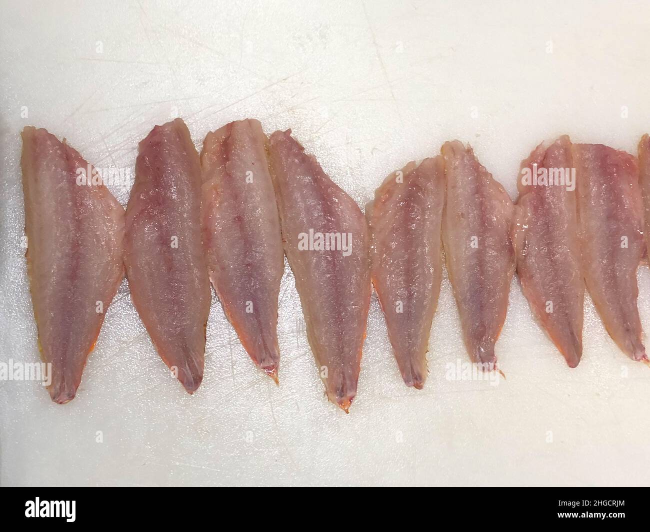 Raw red mullet fillets close-up on white background Stock Photo - Alamy