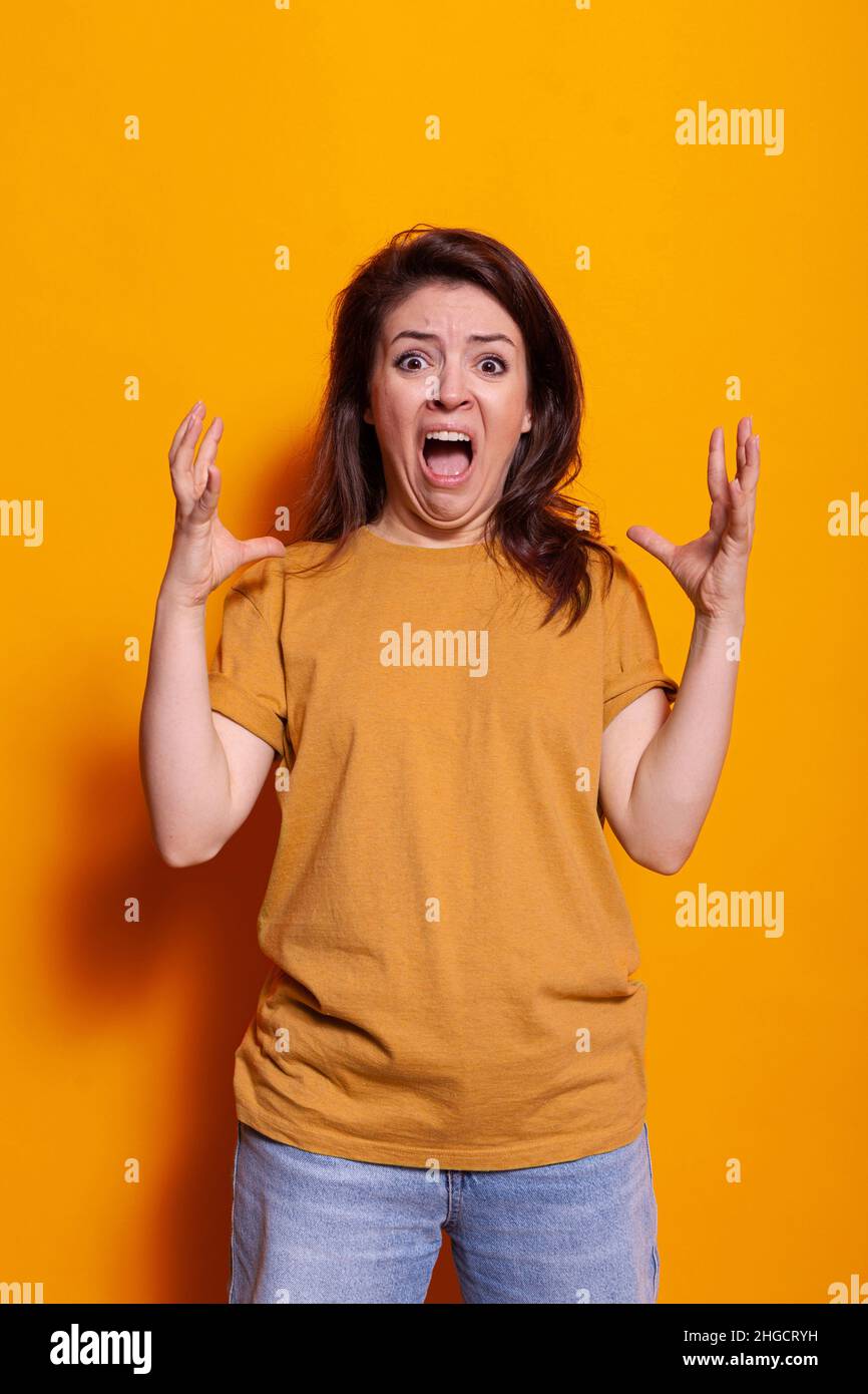 Frightened woman showing face expression of despair, standing over ...