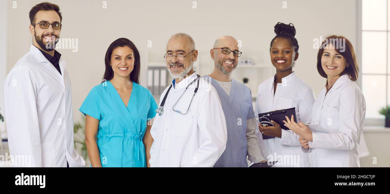 Happy diverse staff of clinic or hospital standing together and smiling ...