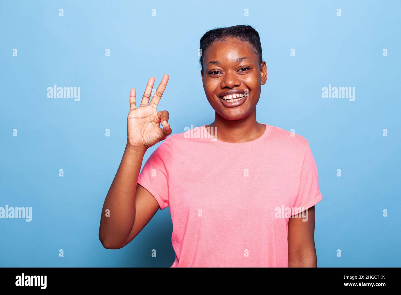 Portrait of positive cheerful african american teenager smiling at ...