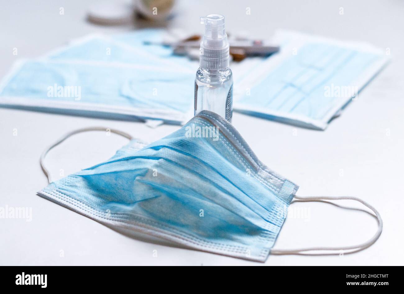hand antiseptic and medical face mask on a white background to minimize ...