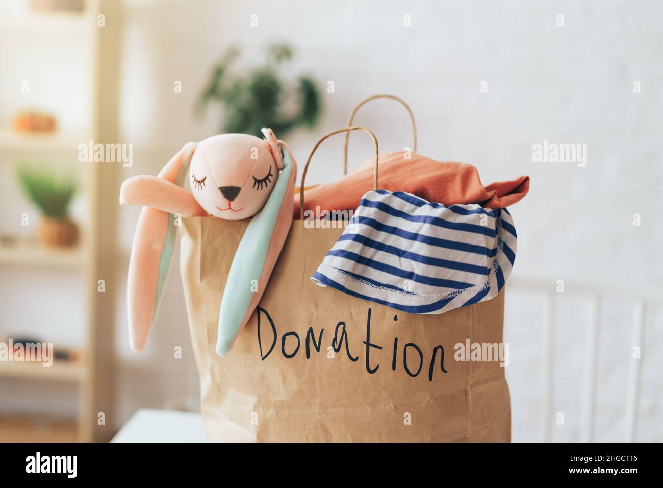Paper bag with used items and toy Stock Photo - Alamy