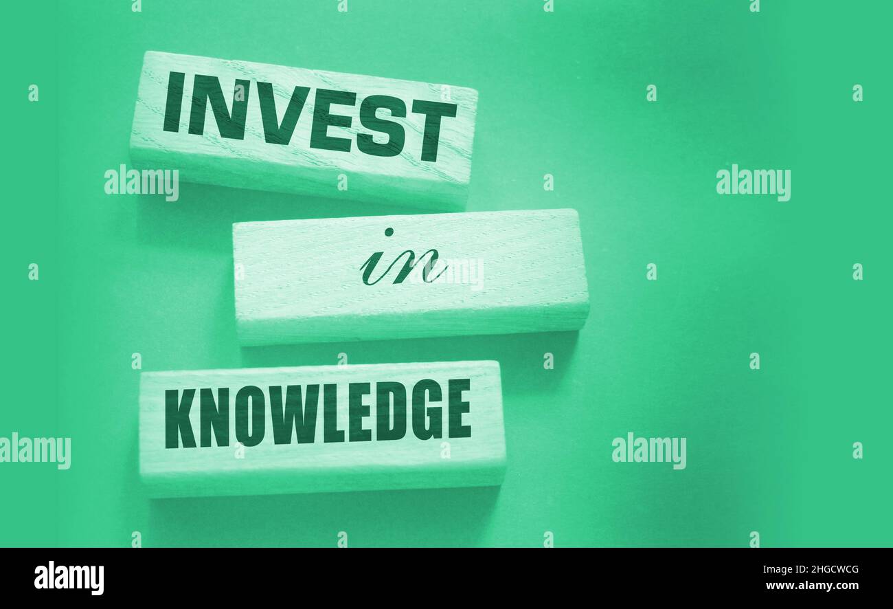 Invest in knowledge words onwooden blocks. Inspirational motivational ...