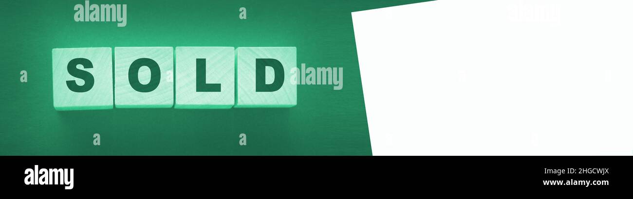 Sold Word Written In Wooden Cubes on black background. Real estate ...