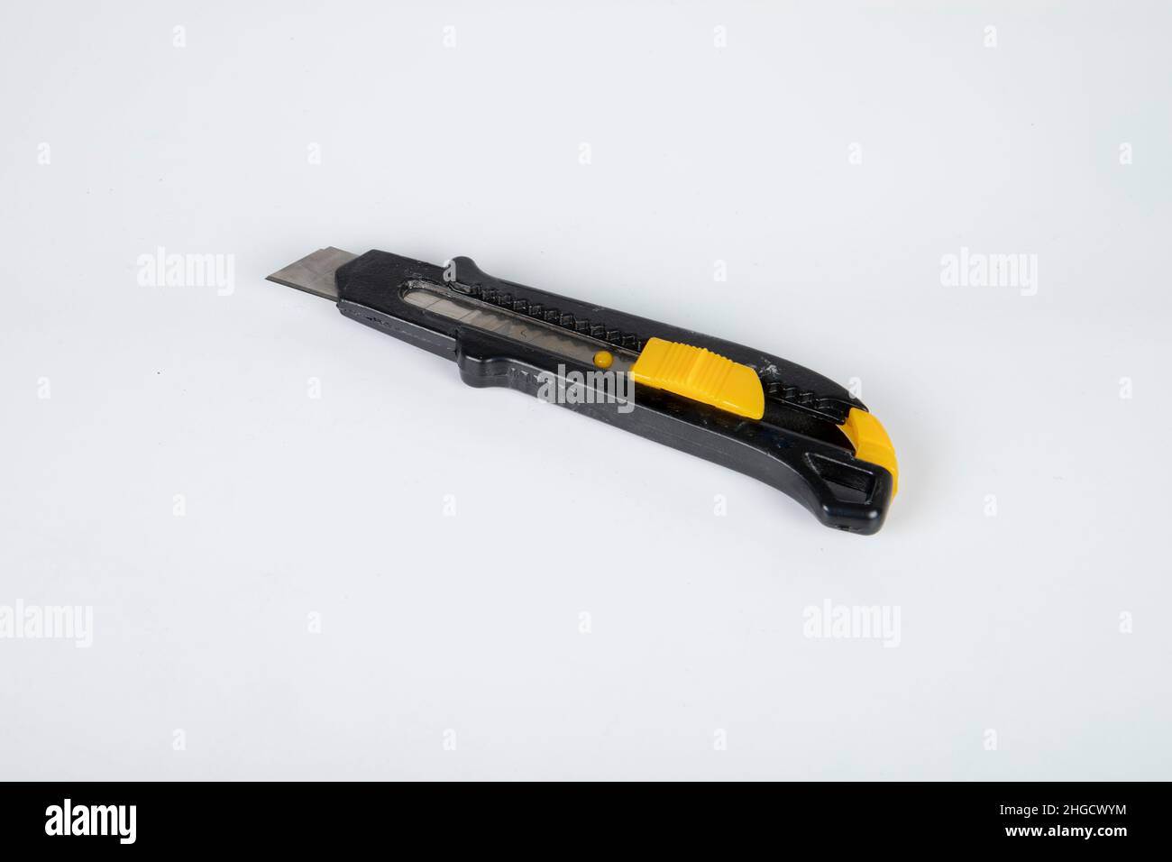 Yellow cutter knife isolated on white background Stock Photo - Alamy