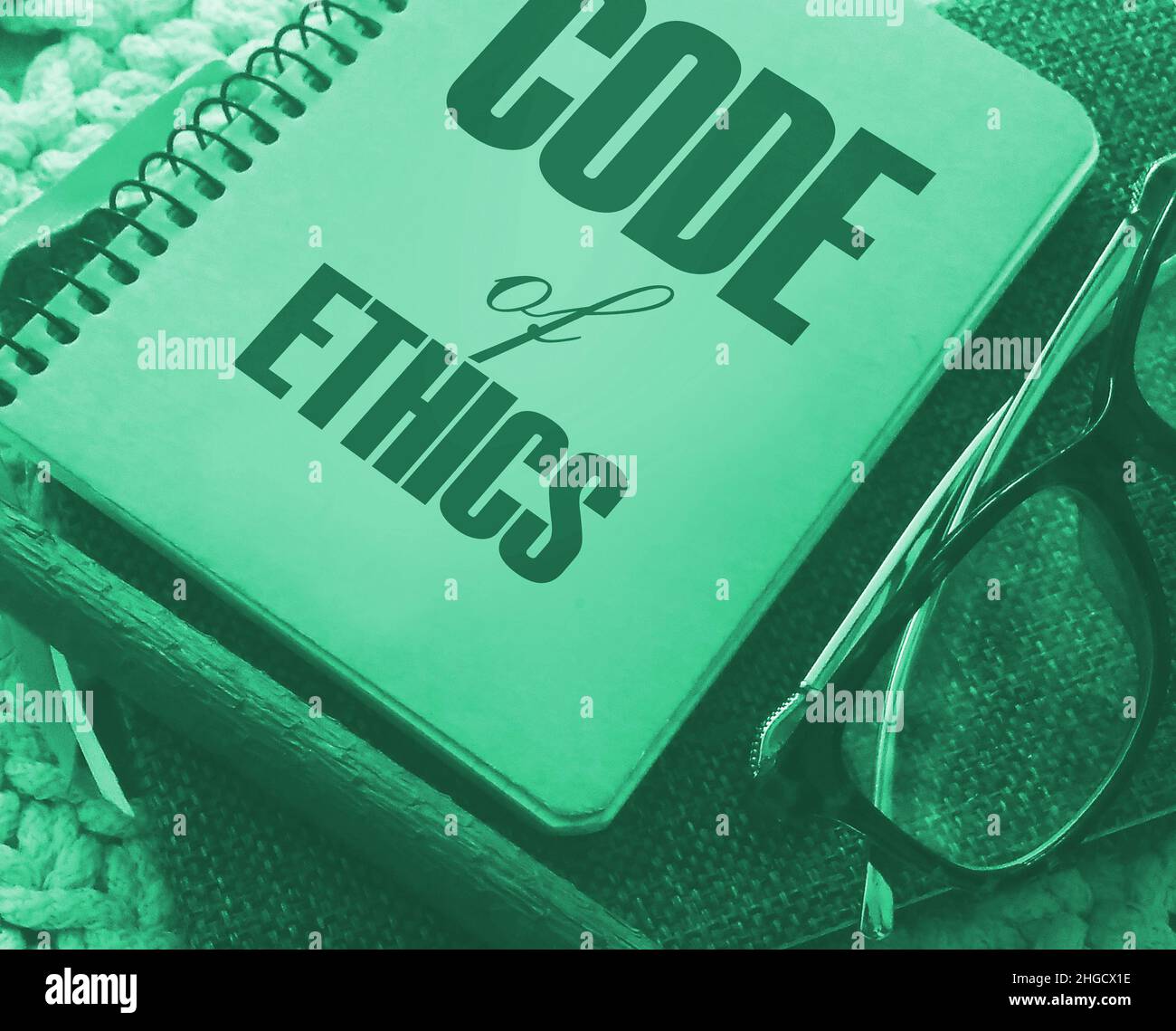 Code Of Ethics words on notebook, pen, glasses, crochet cloth. Business ...