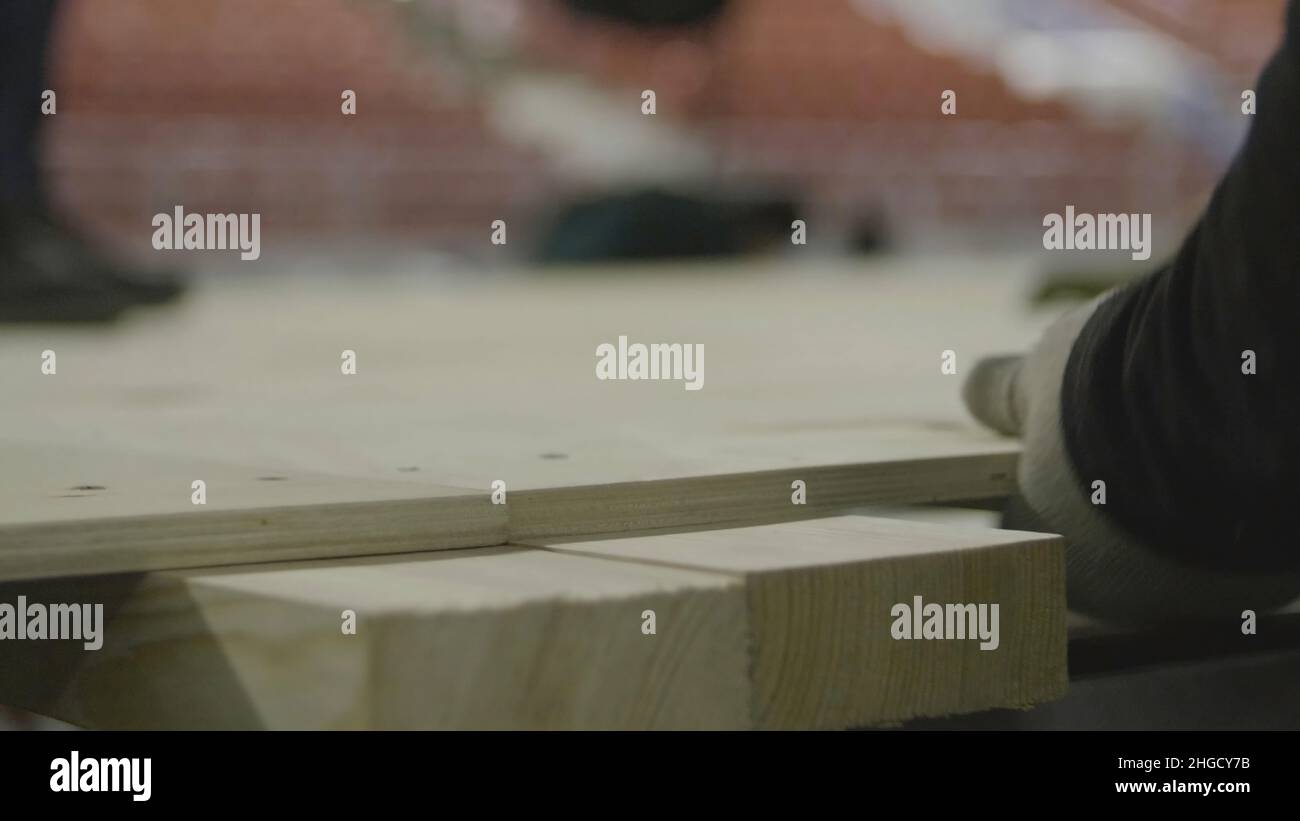 Men collect wood construction. Men workers build a Boxing ring to fight ...