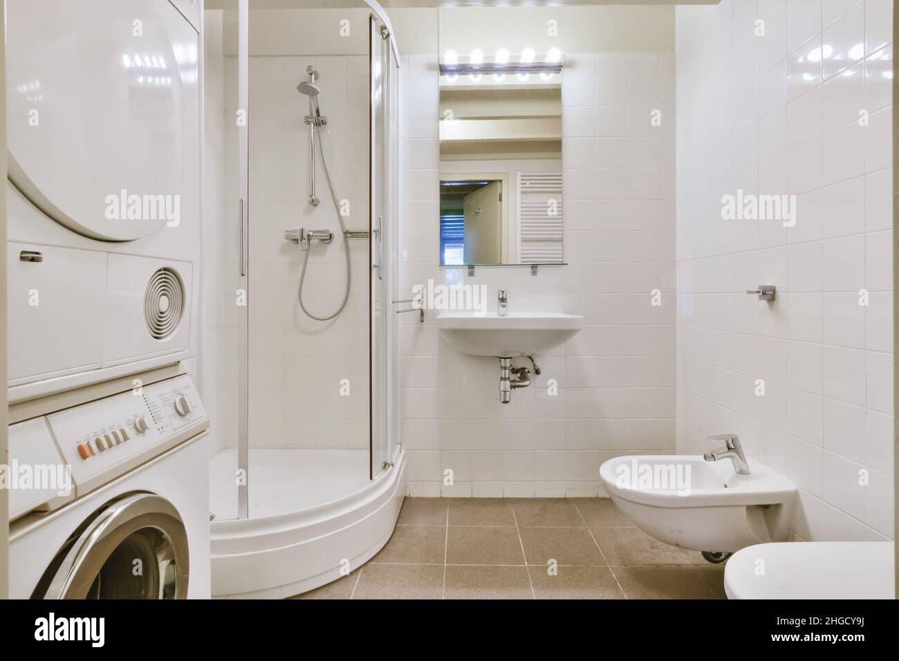 Attractive bathroom with washing machine and shower Stock Photo - Alamy