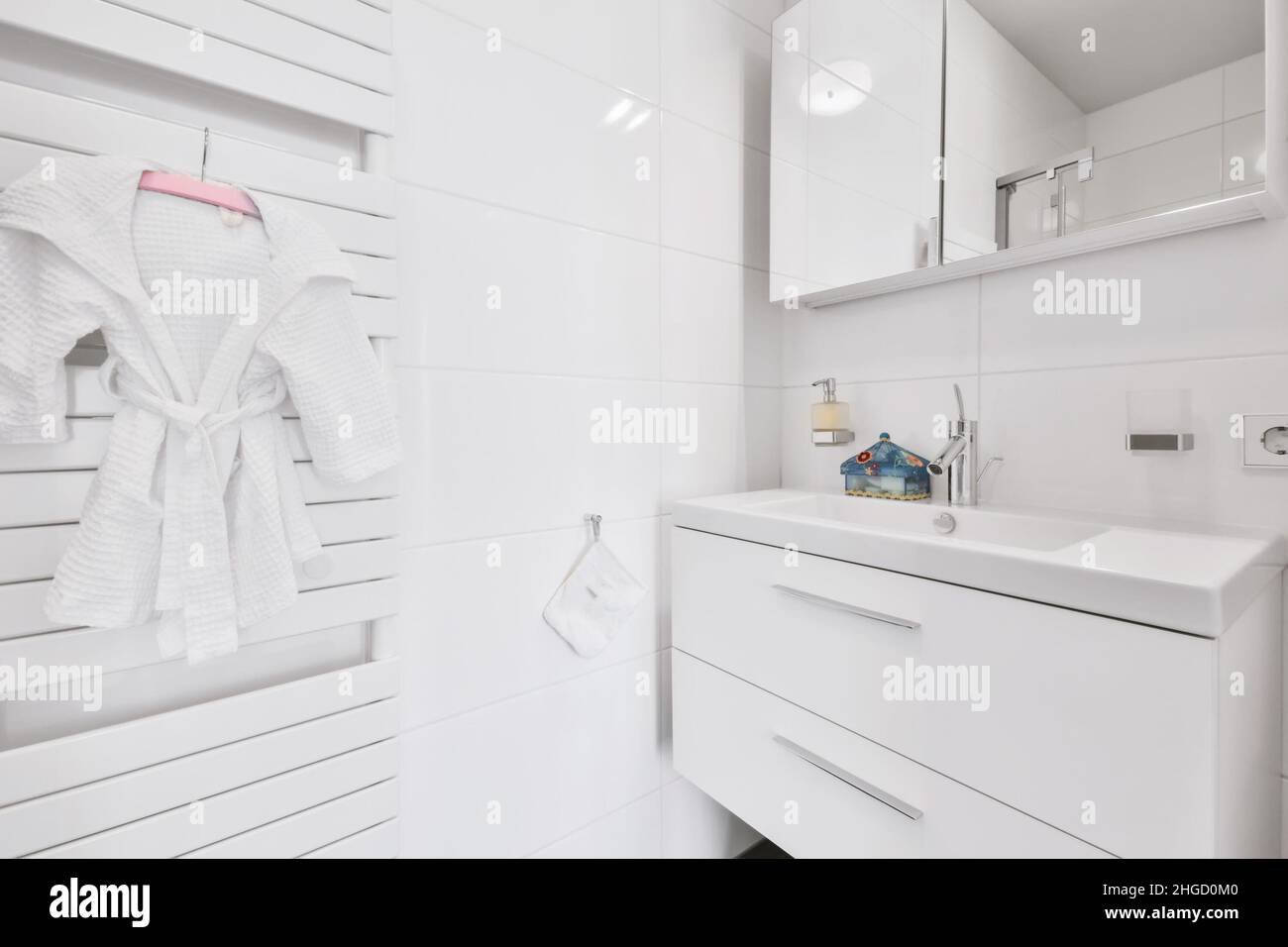 Lovely snow-white bathroom with sink and radiator Stock Photo - Alamy
