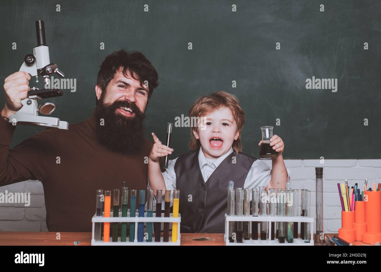 Little kid scientist earning chemistry in school lab. Biology ...