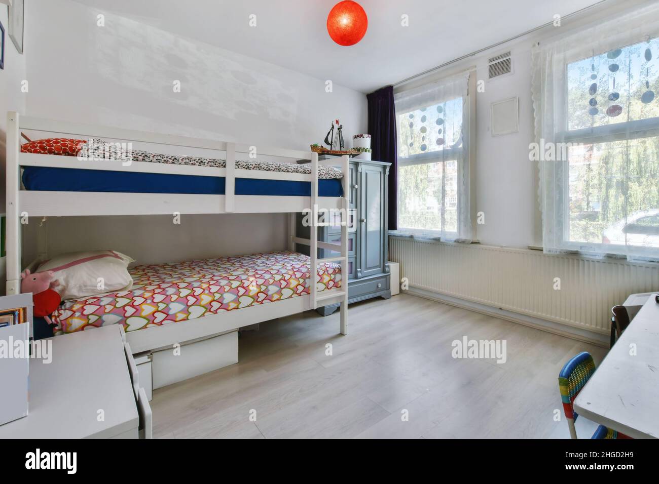 Spectacular bedroom with a bunk bed and two windows Stock Photo - Alamy