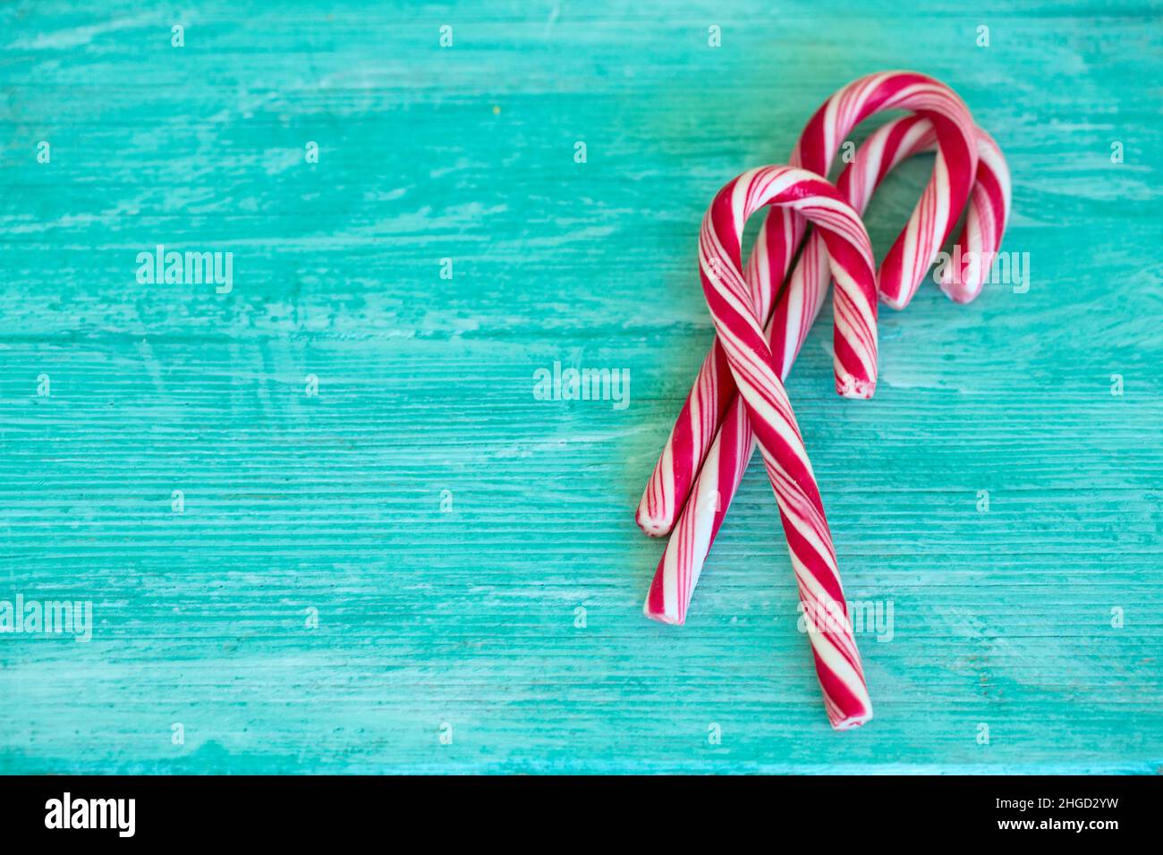 striped candies on turquoise background Stock Photo - Alamy