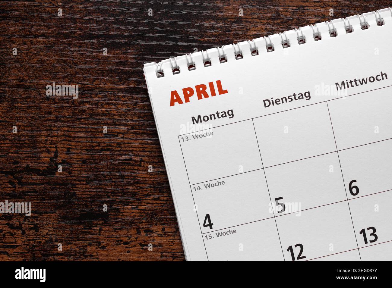 month of april in german calendar or planner on wooden desk Stock Photo ...