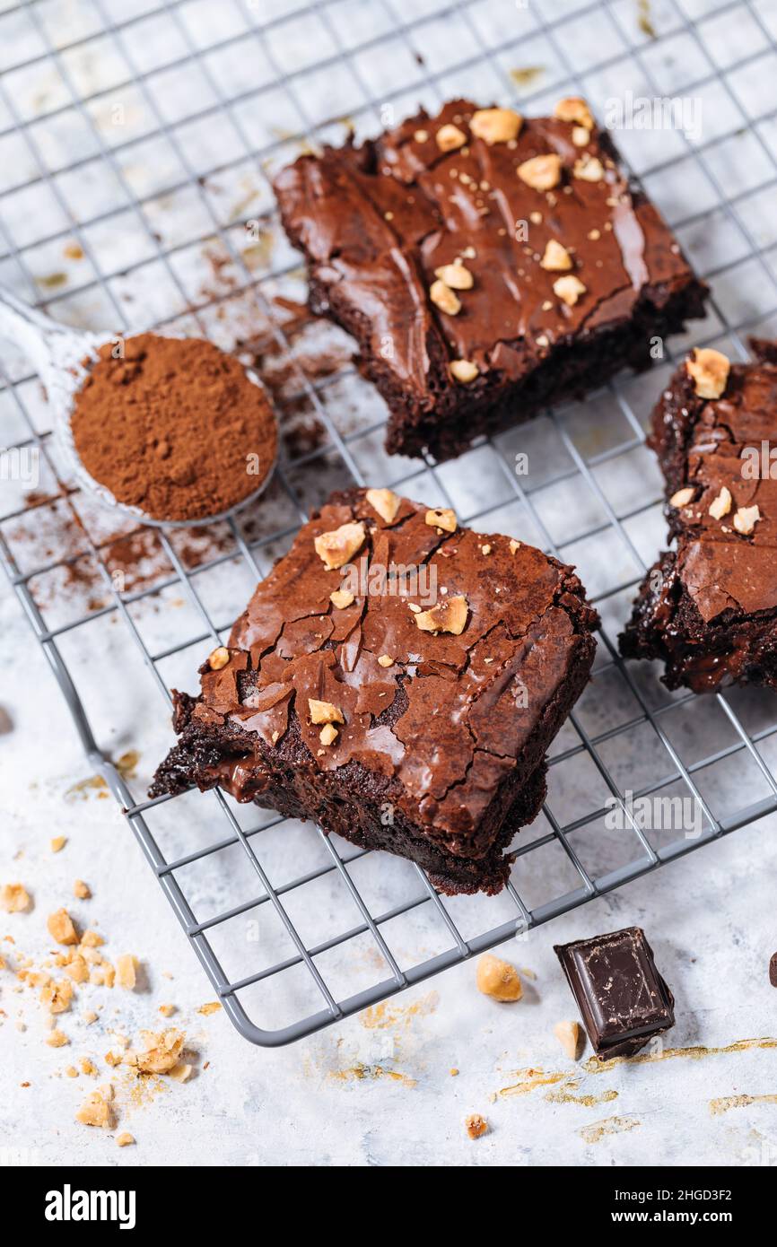 Chocolate fudge brownies with hazelnut crumbs on top, on a tray with ...