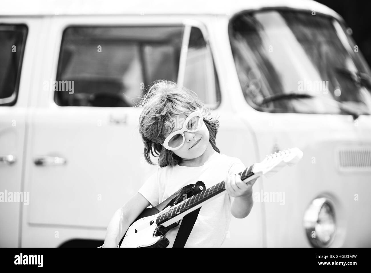 Child singing and playing guitar outside. Retro colorful portrait Stock ...