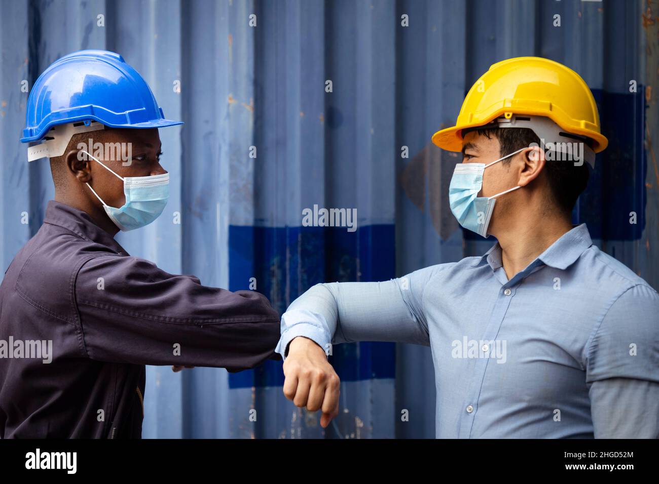 african engineer and caucasian businessman wearing face mask to protect ...