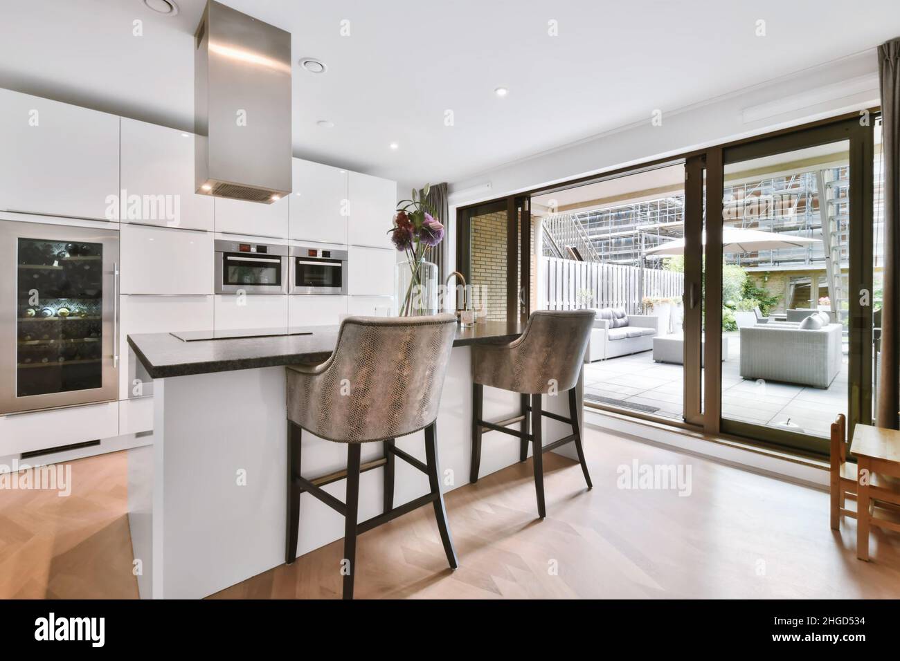 Stylish kitchen with marble countertop and modern extractor hood Stock ...