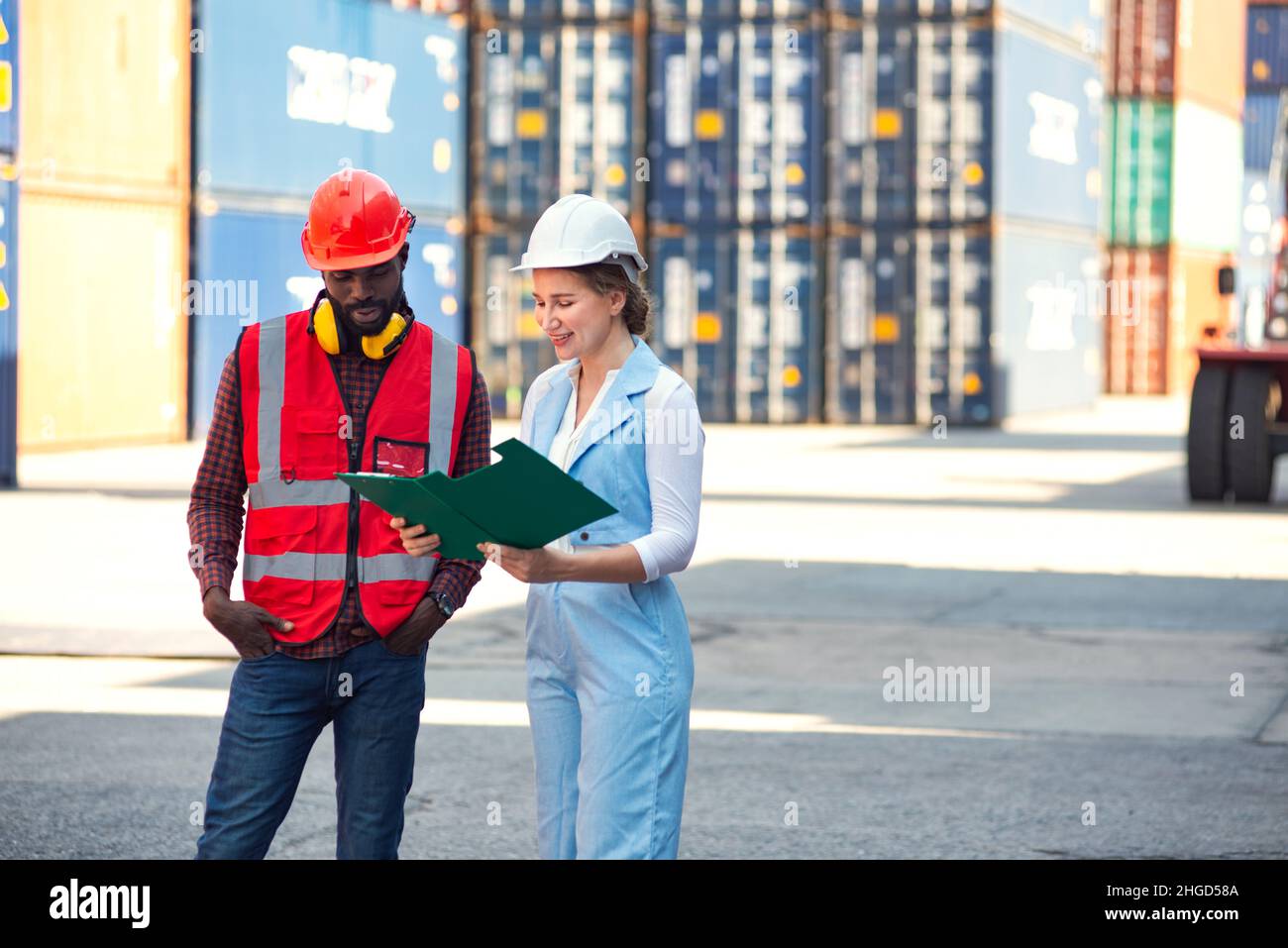 Businesswoman and engineer talking and checking loading Containers box ...