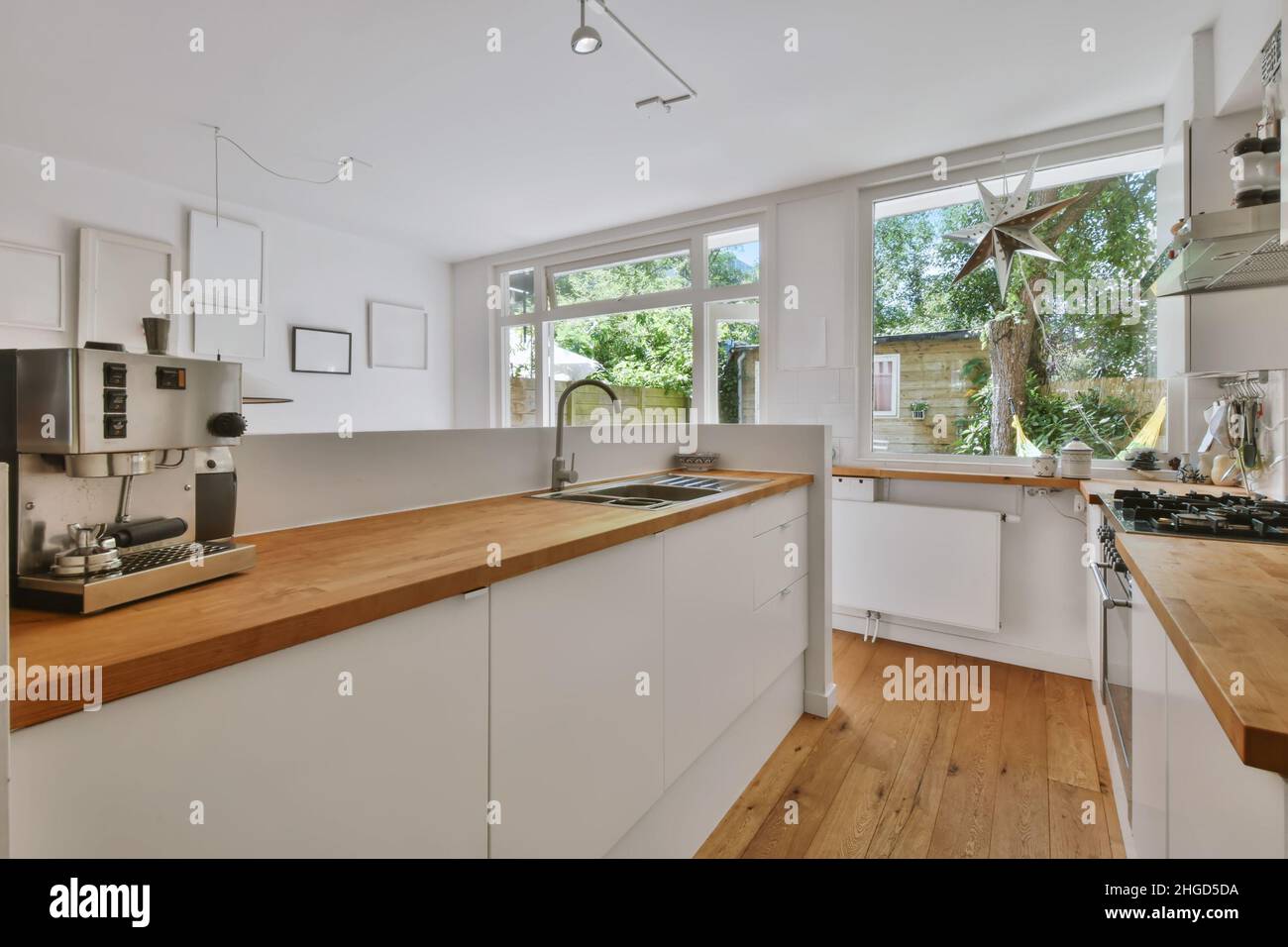 Spectacular kitchen with wooden countertop and large windows Stock ...